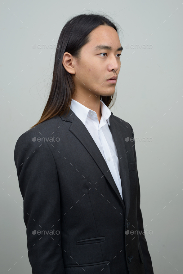 Portrait of young Asian man with long hair Stock Photo by amazingmikael